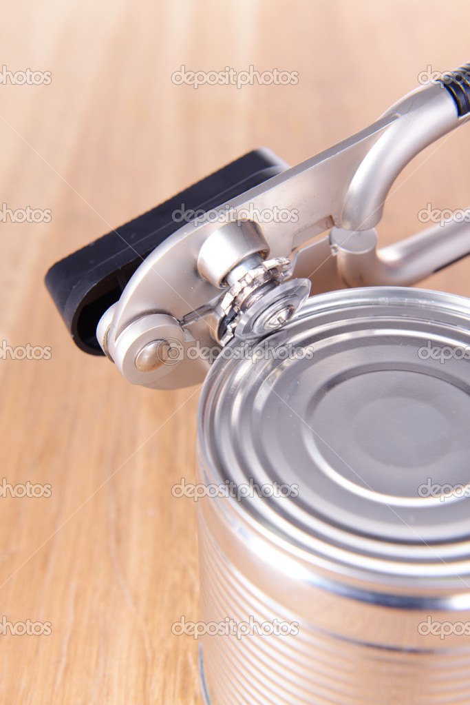 Can piercer with canned on wooden background Stock Photo by ©belchonock ...