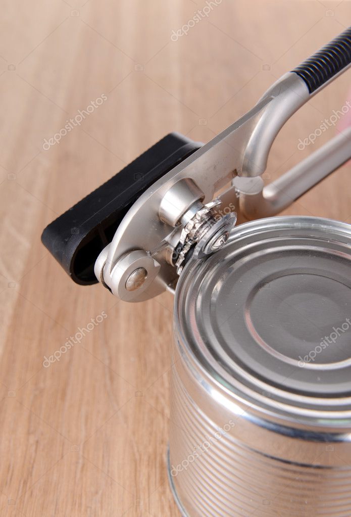Can piercer with canned on wooden background Stock Photo by ©belchonock ...