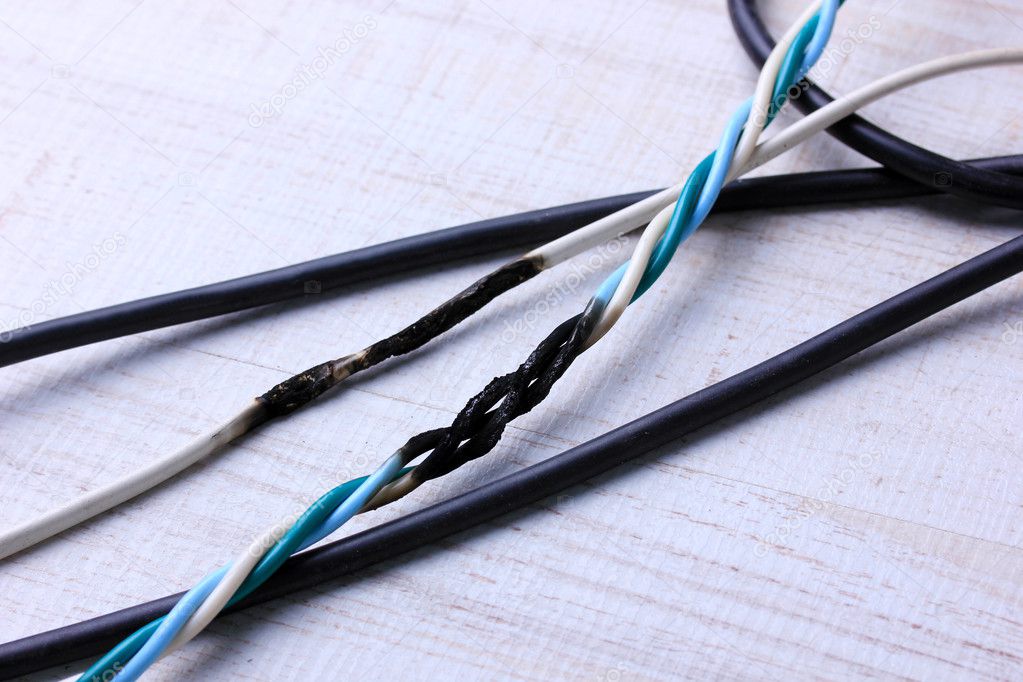 Short circuit, burnt cable, on color wooden background Stock Photo by ...