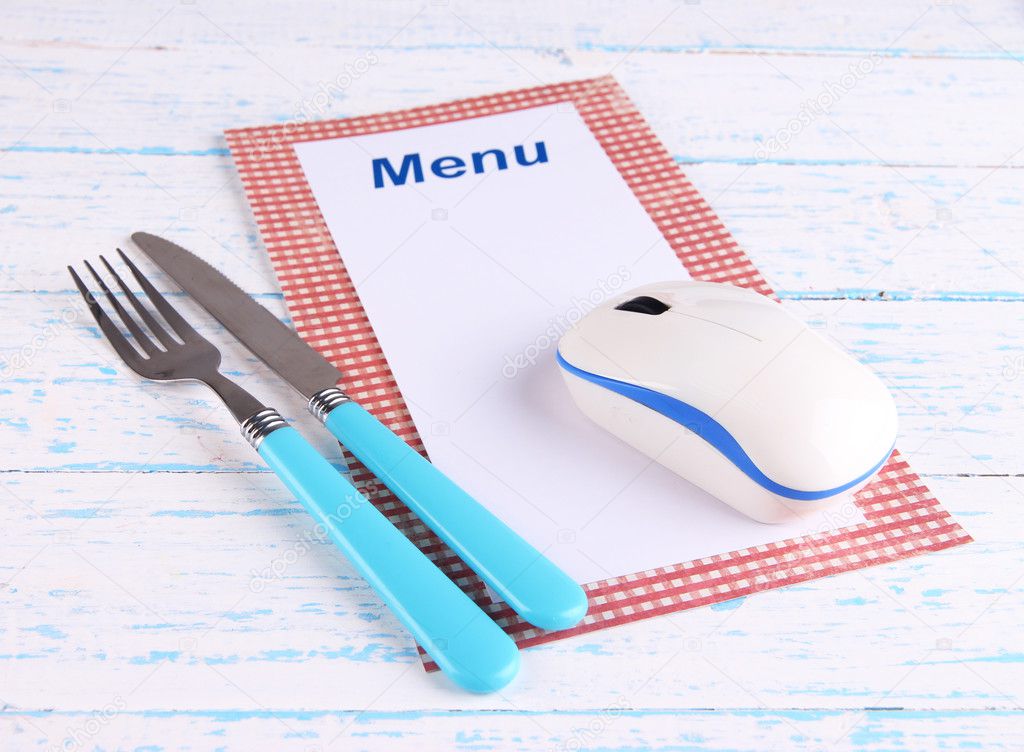 Computer mouse with menu and cutlery on wooden background Stock Photo ...