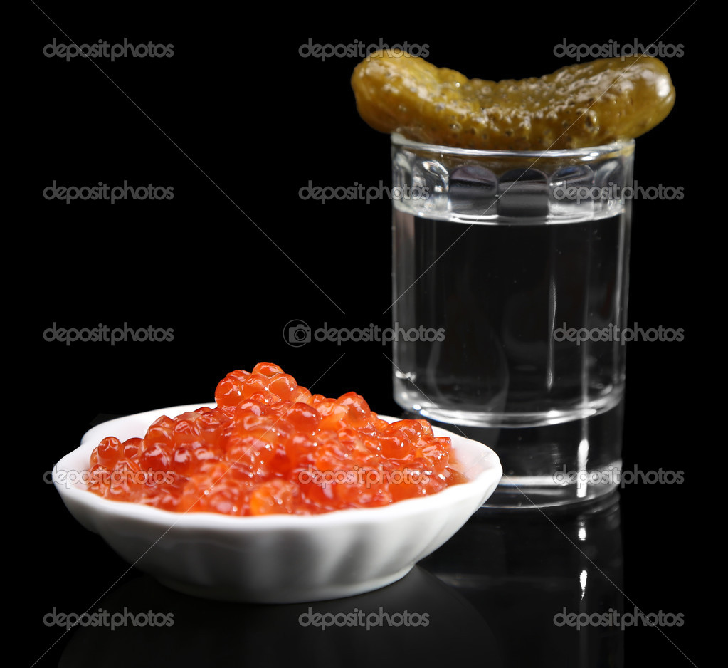 Glass of vodka, red caviar and cucumber isolated on black — Stock Photo ...