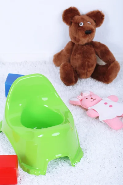 Green potty on home interior background — Stock Photo © belchonock ...