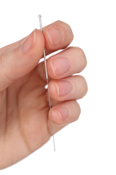 Hand holding needles for acupuncture on hand, close up. Isolated on ...