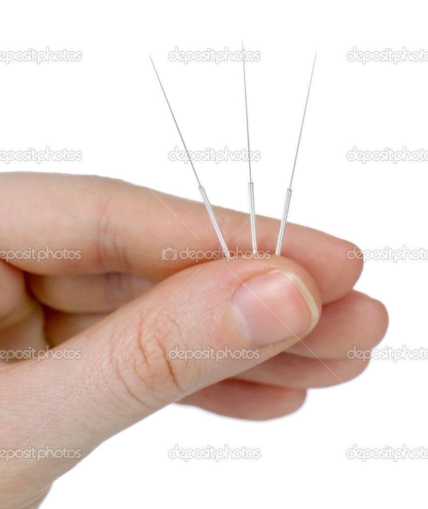 Hand holding needles for acupuncture on hand, close up. Isolated on ...