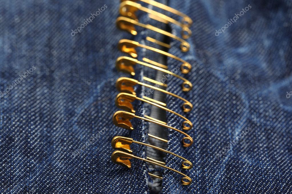 Safety pins on fabric background — Stock Photo © belchonock #43870857
