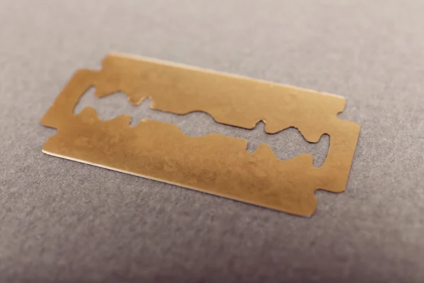 Razor blade on color background — Stock Photo © belchonock #43725881