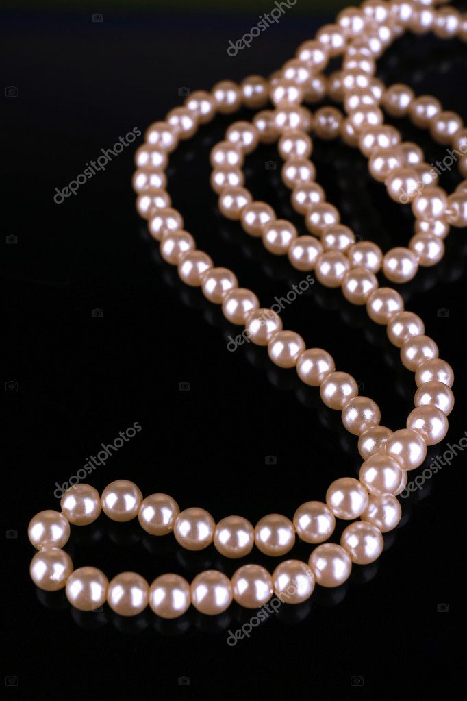 Beautiful pearls on black background Stock Photo by ©belchonock 45133381