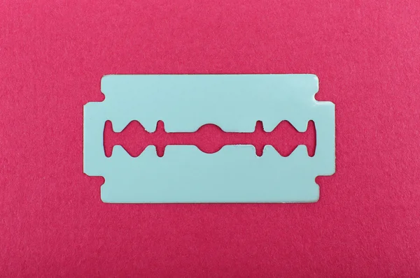 Razor blade on color background — Stock Photo © belchonock #43725881