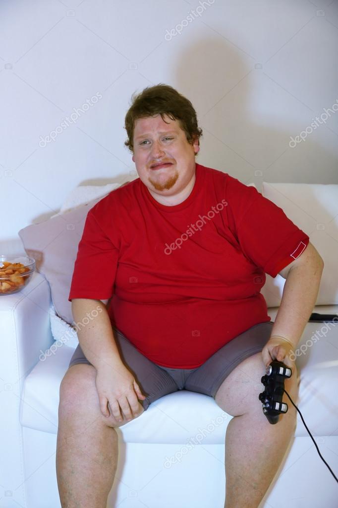 Fat man playing video games Stock Photo by ©belchonock 46203651