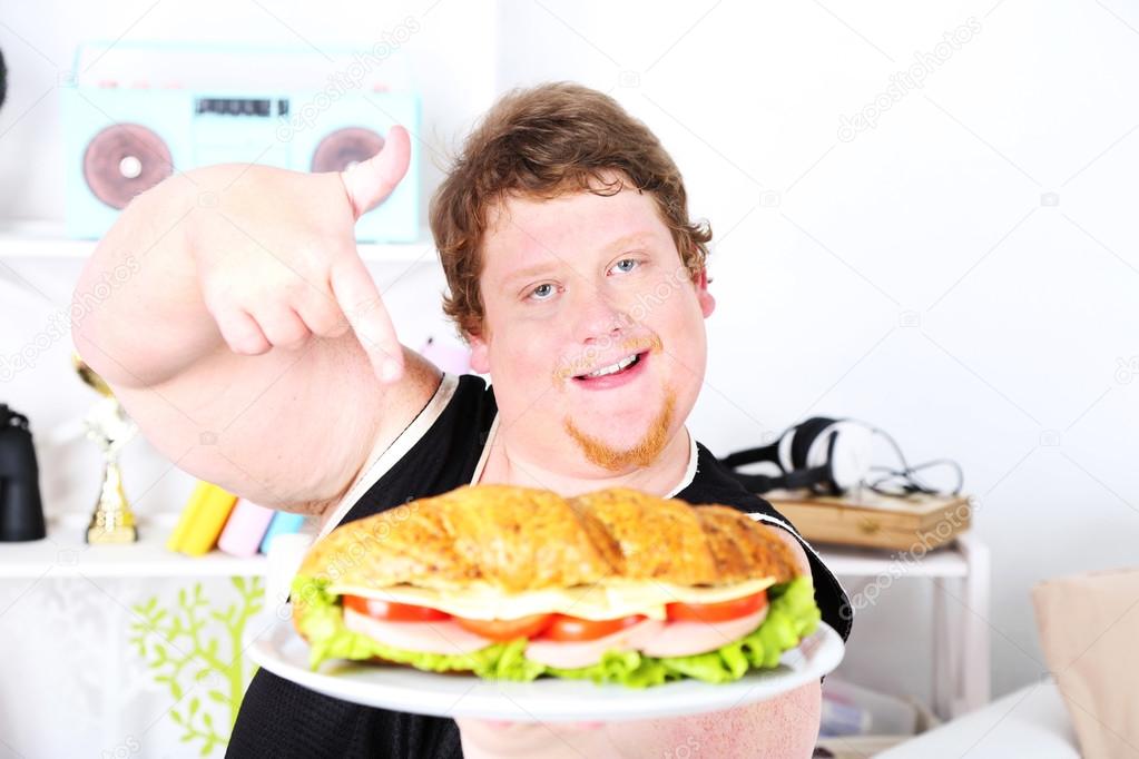 Fat man eating sandwich Stock Photo by ©belchonock 46203785