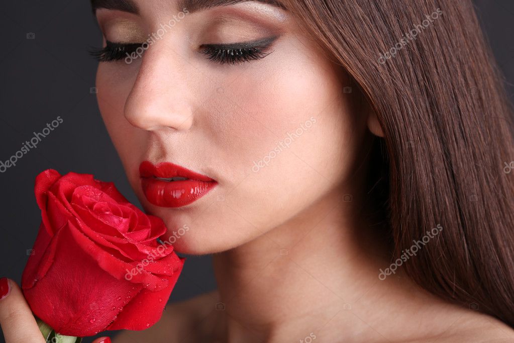 Girl with red lips and rose on dark background Stock Photo by ...