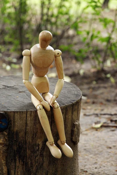 Wooden pose puppet sitting on wooden bench, outdoors — Stock Photo ...