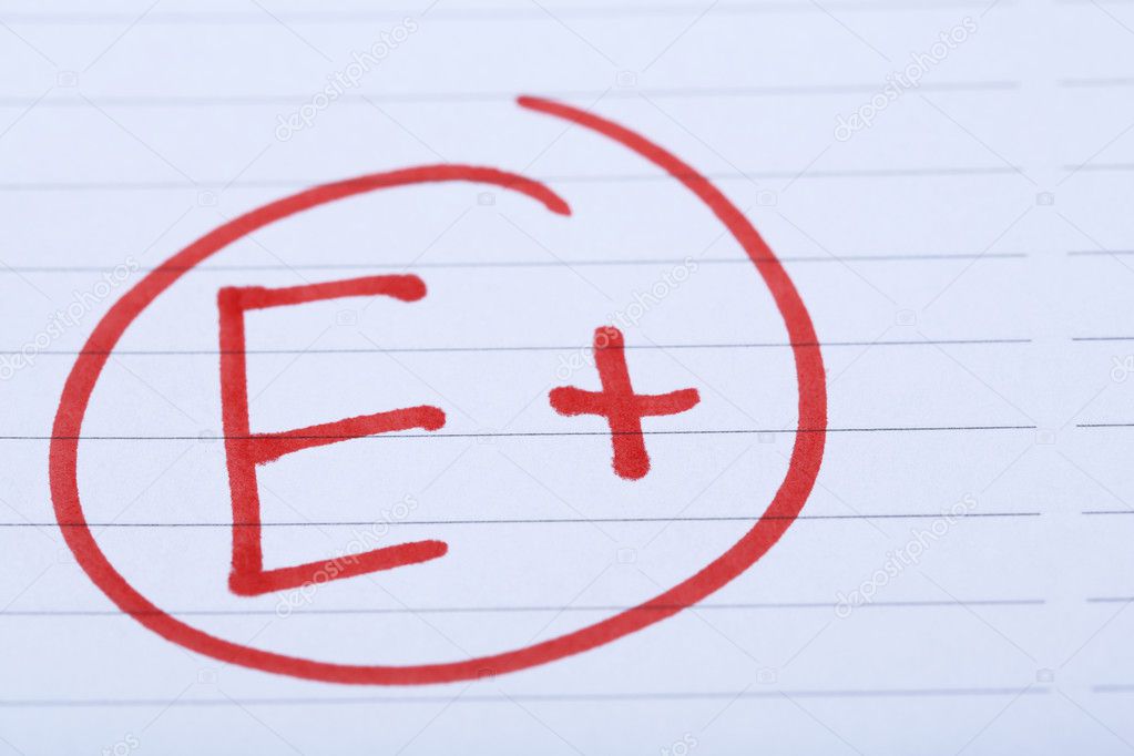 Grade E plus written on an exam paper — Stock Photo © belchonock #48255853