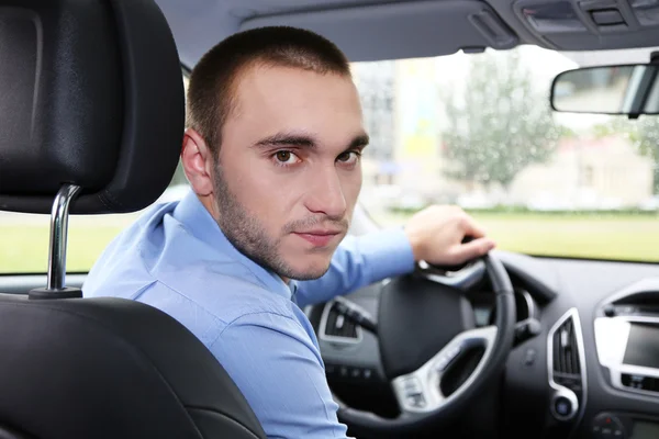 Handsome young man in new car driving — Stock Photo © SIphotography ...