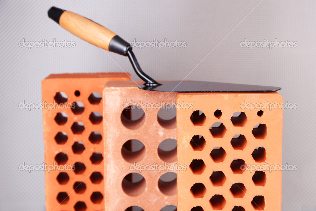 Metal tool for building and bricks on bright background — Stock Photo ...