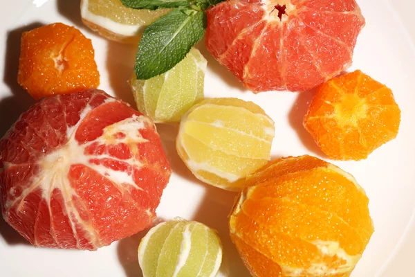 Citrus fruits without skin on tray, on wooden background Stock Photo by ...