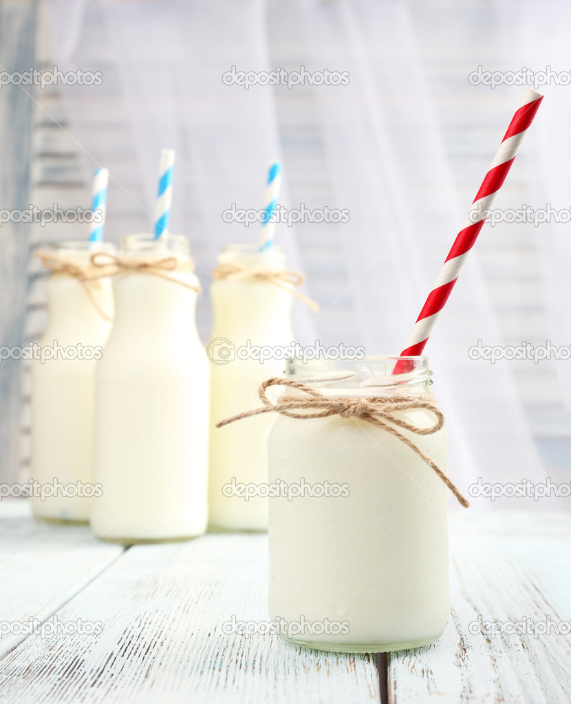 Milk in bottles with straws Stock Photo by ©belchonock 49822537