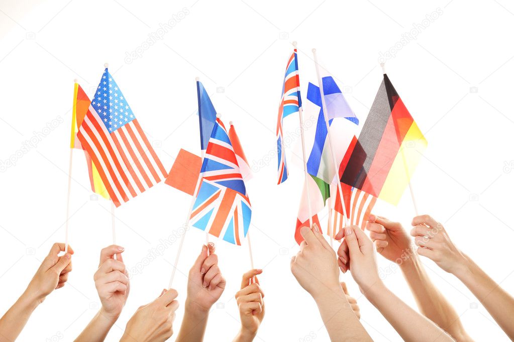 Hands holding different flags Stock Photo by ©belchonock 49845401
