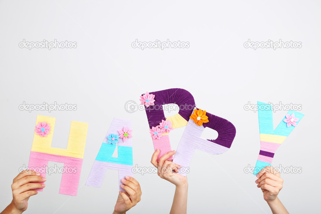 Hands holding up letters Stock Photo by ©belchonock 50216347