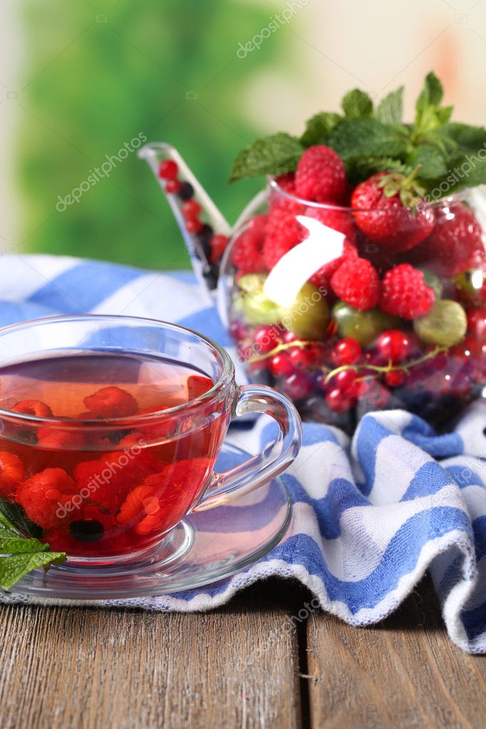 Fruit red tea with wild berries in glass cup, on wooden table, on ...