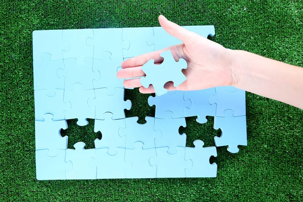 Hand holding puzzle piece Stock Photo by ©belchonock 50826807