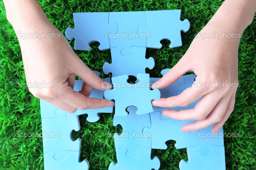 Hands holding puzzle piece Stock Photo by ©belchonock 50325893