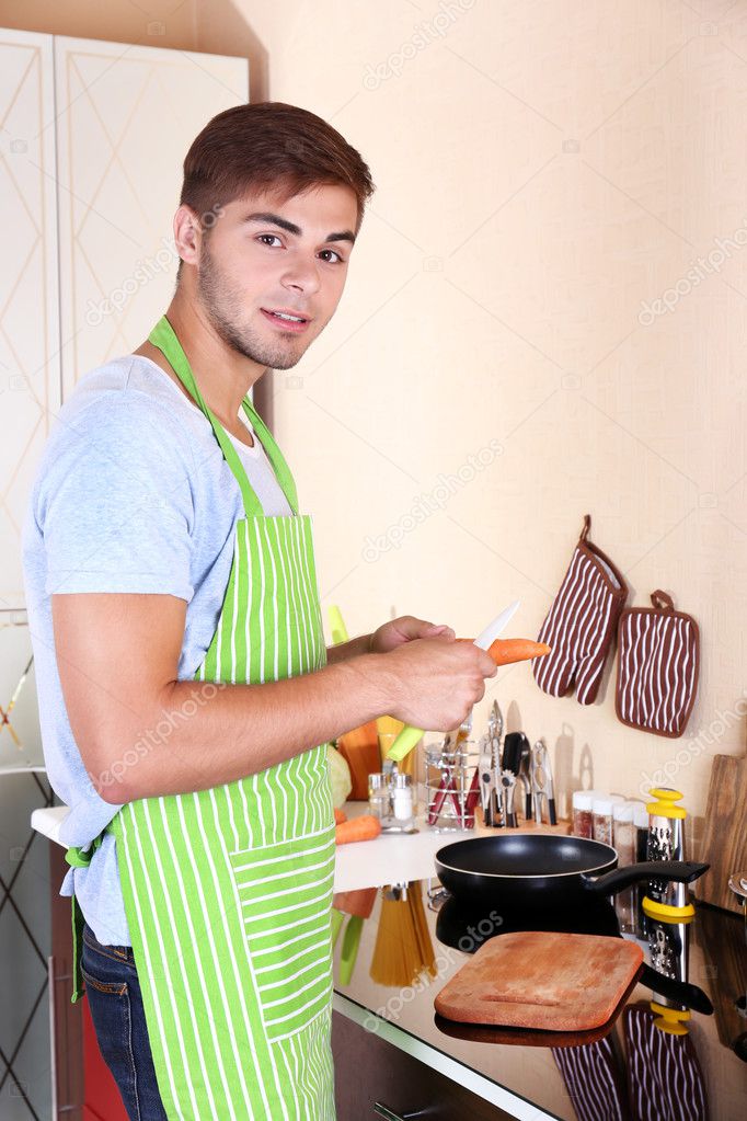 Man cooking in kitchen Stock Photo by ©belchonock 50326535