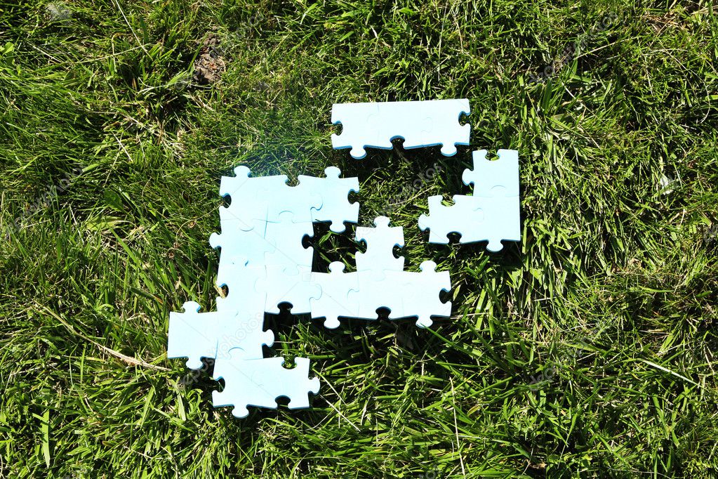 Puzzle pieces on green grass background. Green space concept Stock ...