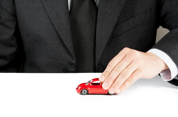 Toy car in the hand of business man concept for insurance, buying ...