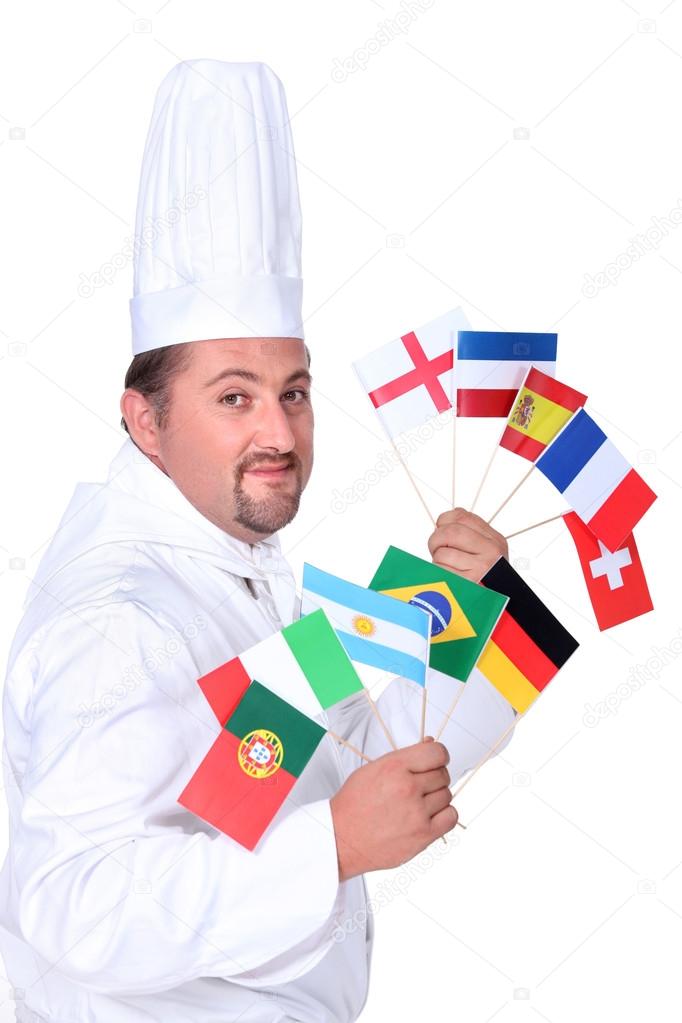 Chef holding up flags from around the world — Stock Photo ...