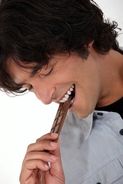Man eating a bar of chocolate — Stock Photo © photography33 #14559343