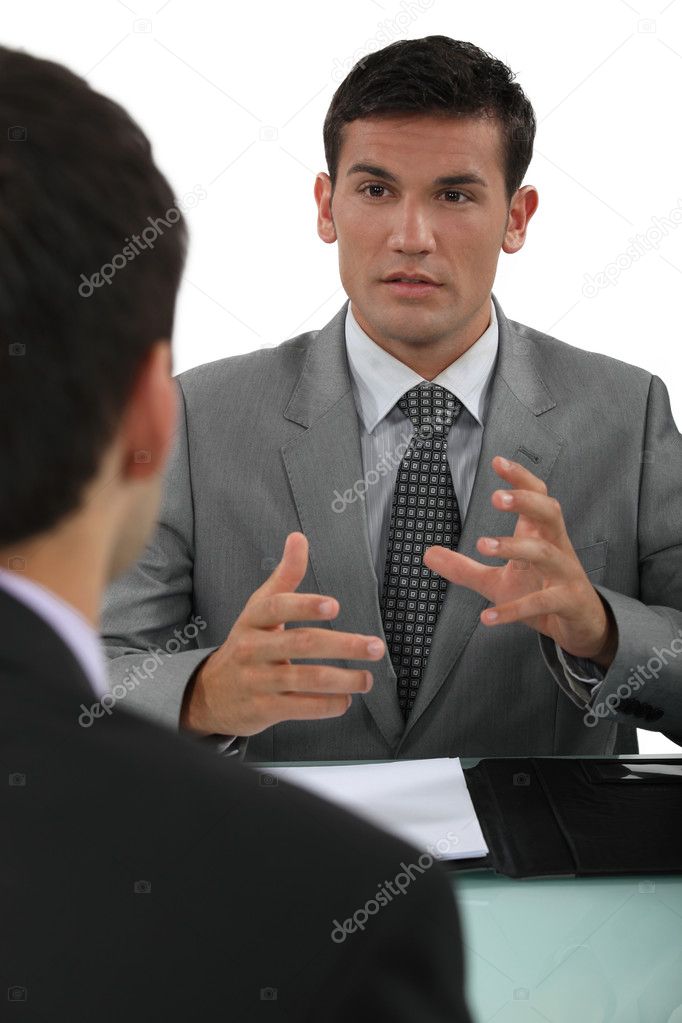 Businessman explaining something to a colleague Stock Photo by ... Businessman explaining something to a colleague Stock Photo by ...