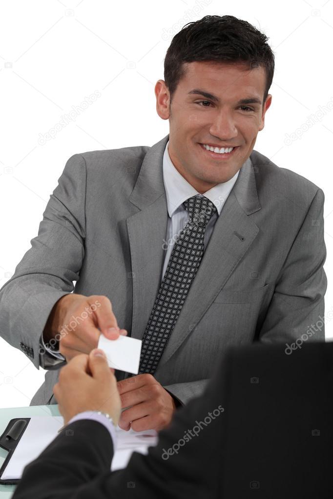 Man handing over his business card to a potential client — Stock Photo ...