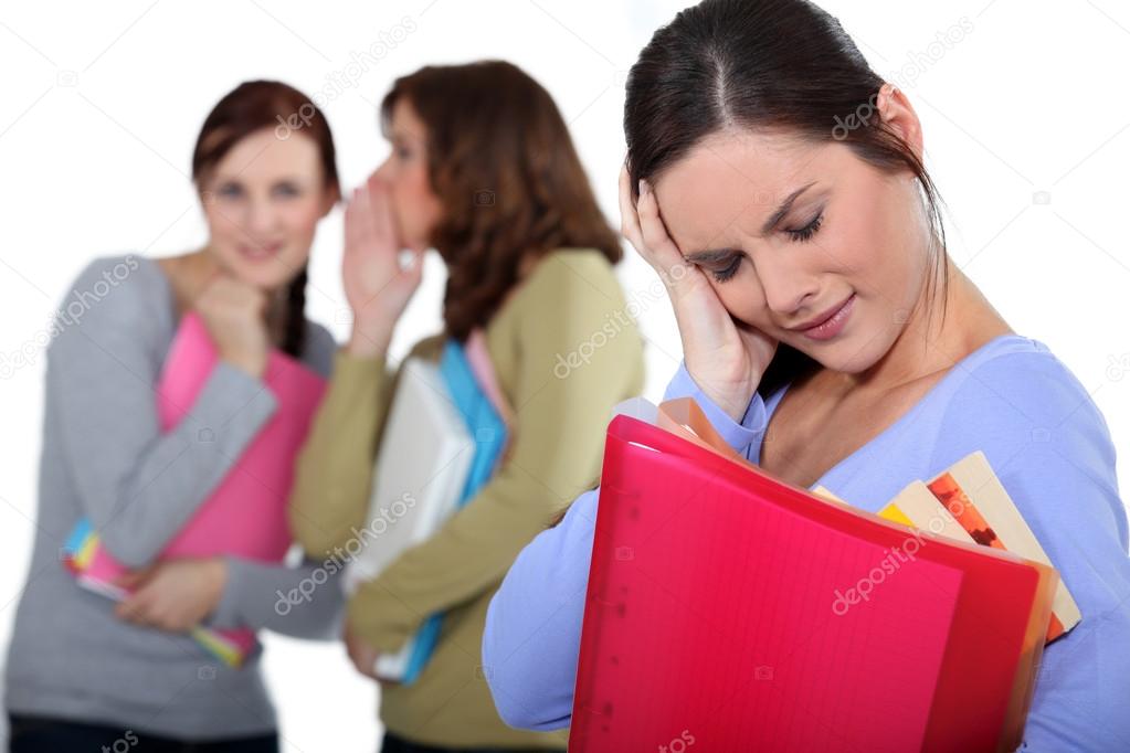 Women whispering behind a confused colleague — Stock Photo ...