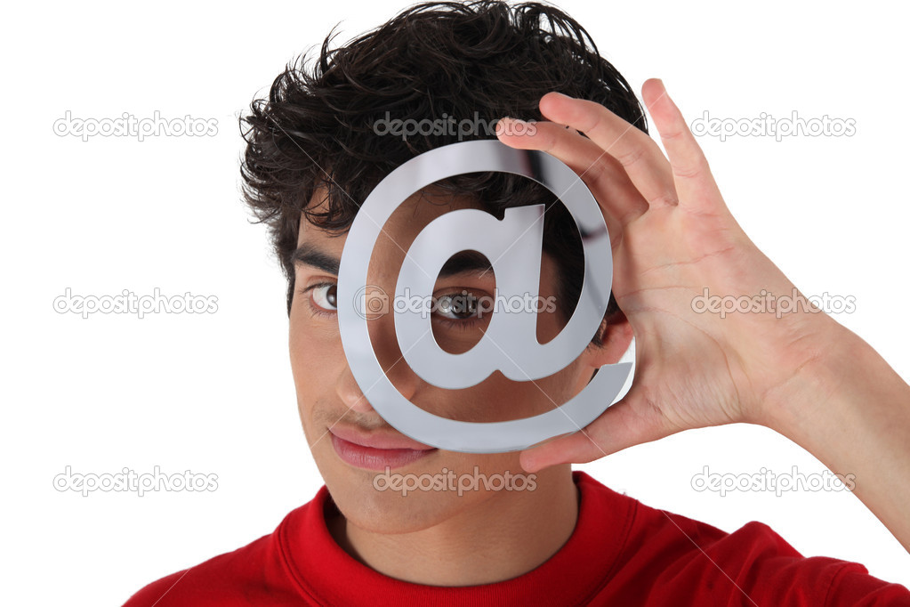 Young man with an @ sign — Stock Photo © photography33 #17345341