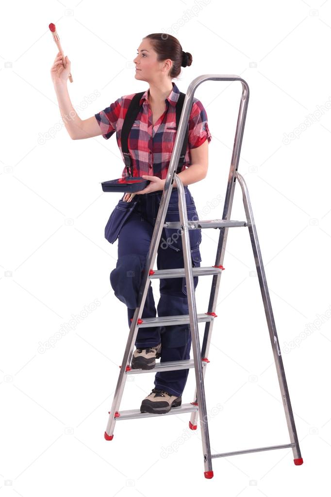 Female decorator climbing a ladder — Stock Photo © photography33 #17473677
