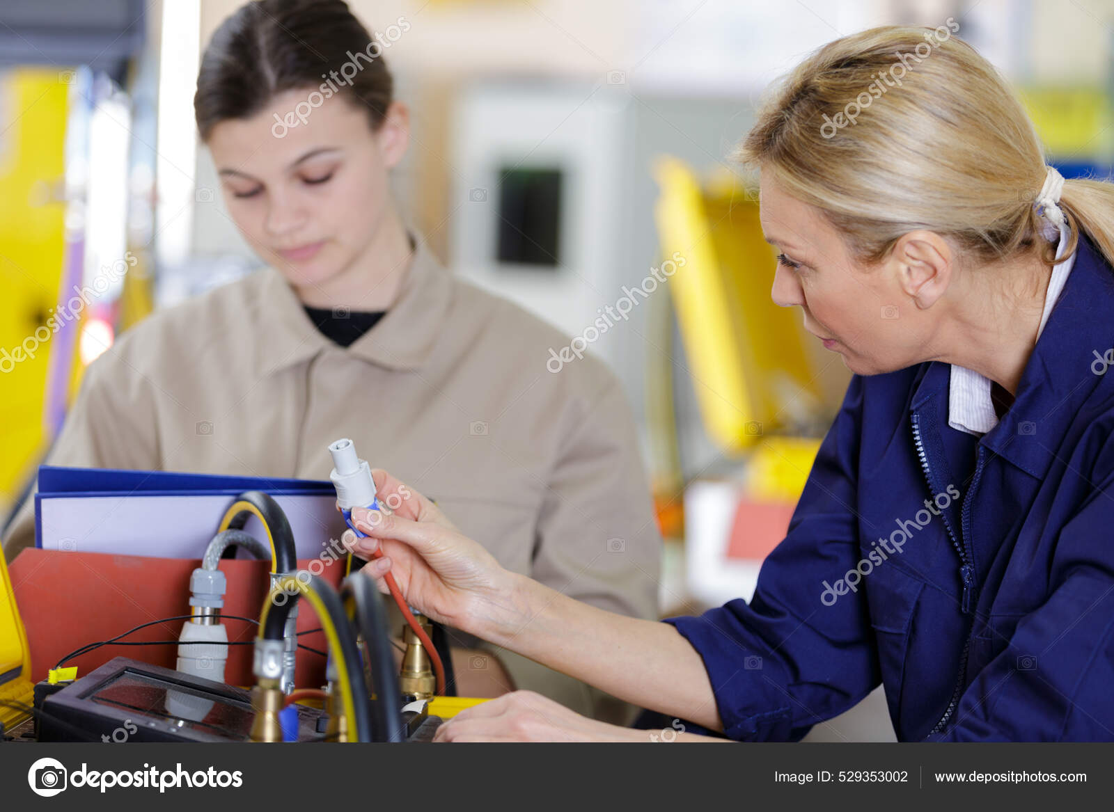 Female Engineer Connecting Hoses Apprentice Stock Photo by ...