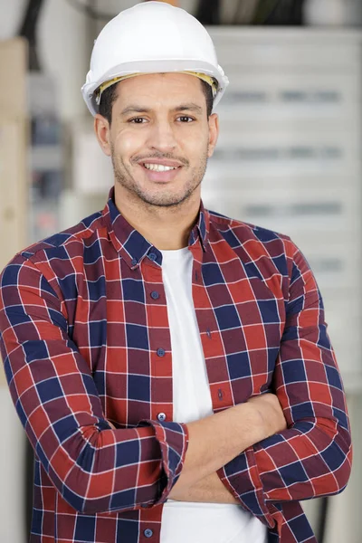 happy smiling worker in uniform with crossed arms - Stock Image ...
