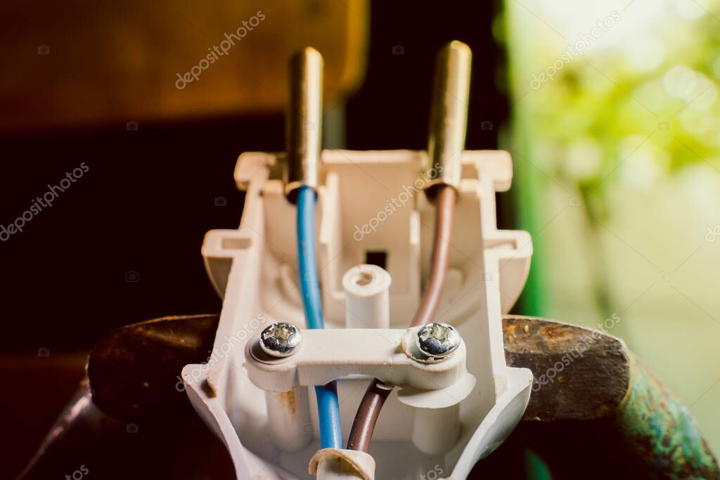 Connecting the wires of an electrical appliance into an electrical plug ...