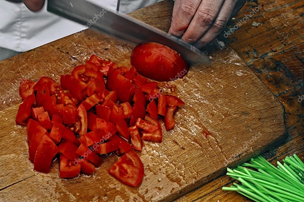 Cook cut the tomatoes into pieces — Stock Photo © florin1961 #16123471