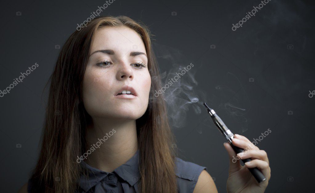Elegant woman smoking e-cigarette with smoke Stock Photo by ...