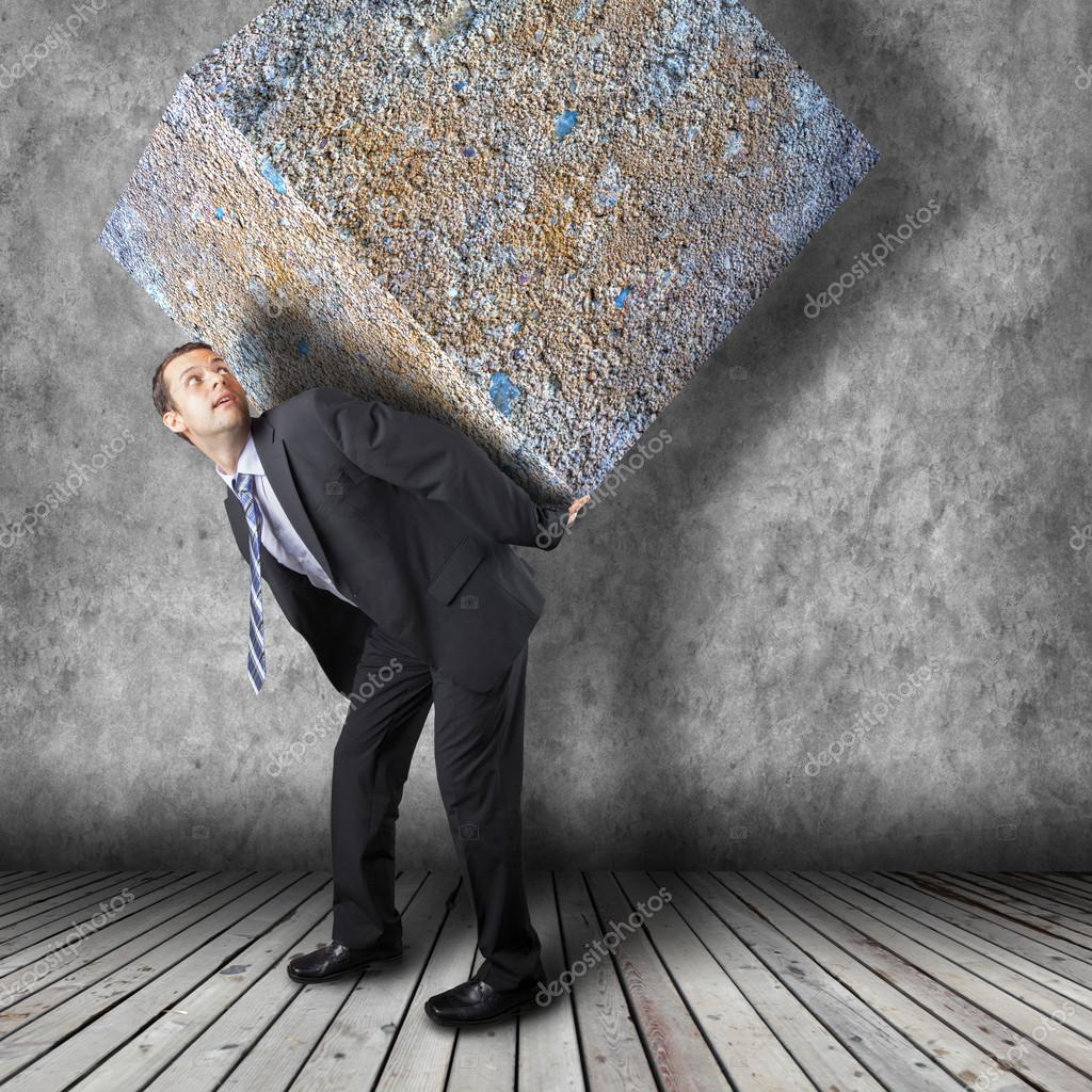 Businessman carrying heavy stone package — Stock Photo © semisatch ...