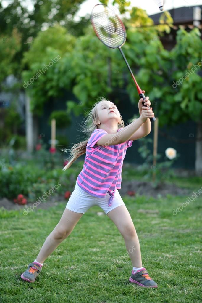Cute little girl playing badminton Stock Photo by ©muro 49391641