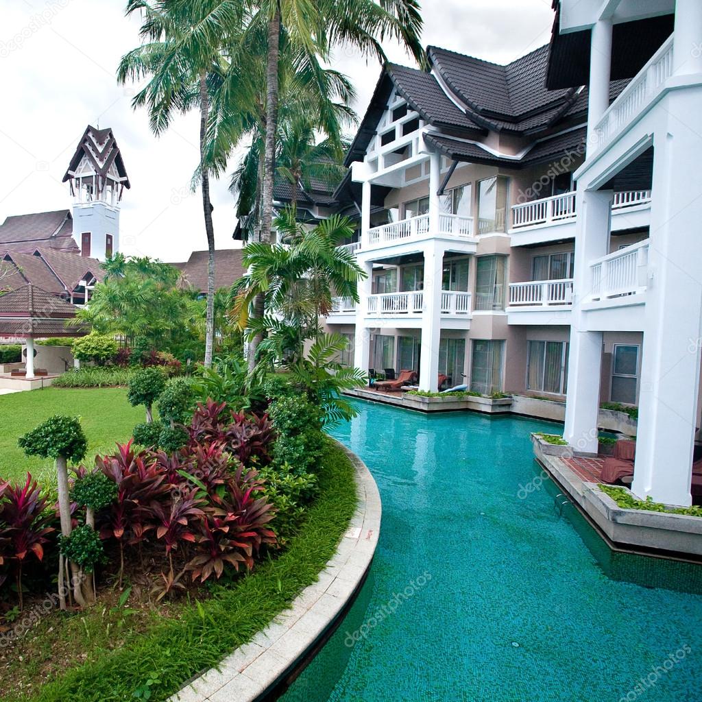 Landscape swimming pool within compound of tropical resort hotel ...