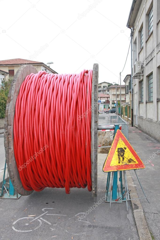 Roadworks and a coil of wire with the excavation — Stock Photo ...