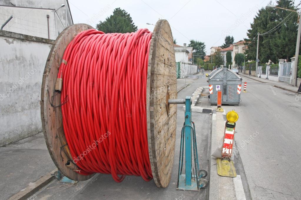 Spool of cable and fiber optics in the road during the outdoor a ...