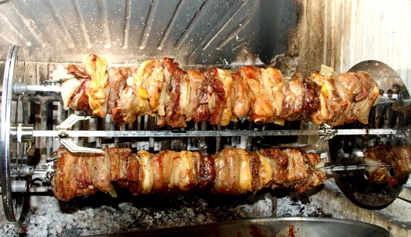 Meat skewers cooked to spit in the fireplace swivel Stock Photo by ...