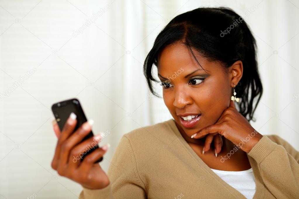 Pensive black woman using her cellphone Stock Photo by ©pablocalvog ...