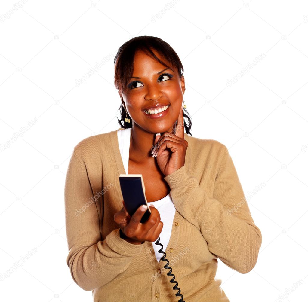 Smiling young woman holding phone handset — Stock Photo #13334754 Smiling young woman holding phone handset — Stock Photo #13334754