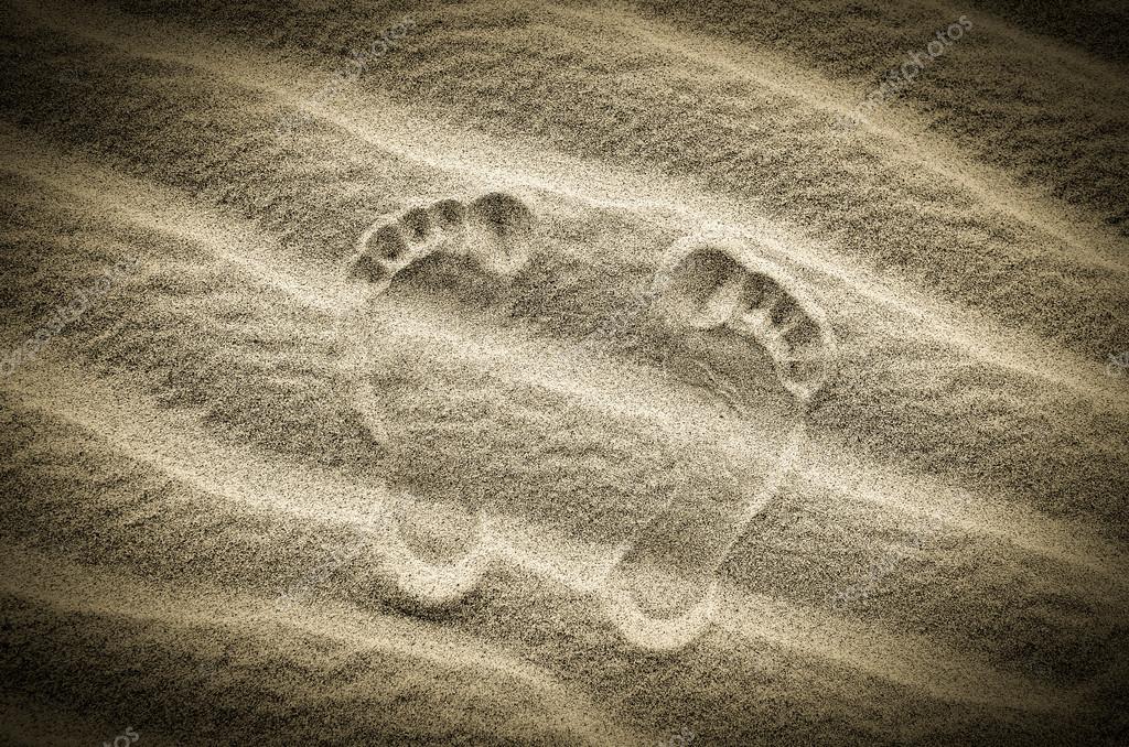 Two footprints in sand on the desert beach — Stock Photo © martinm303 ...